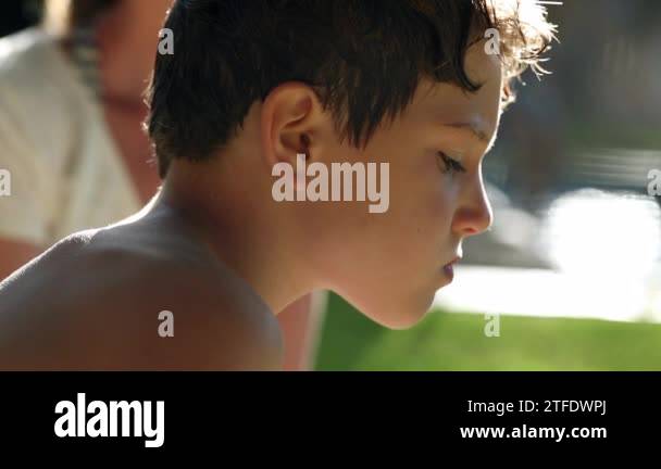 Contemplative young boy thinking deeply. Candid profile of pensive ...