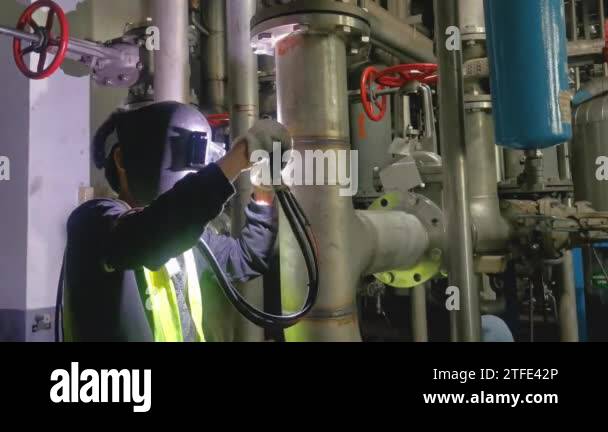 Professional Welder Wears Helmet Working in Heavy Industry Process Pipe ...