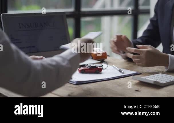 A car salesman in a stylish suit offers successful businessmen a choice ...