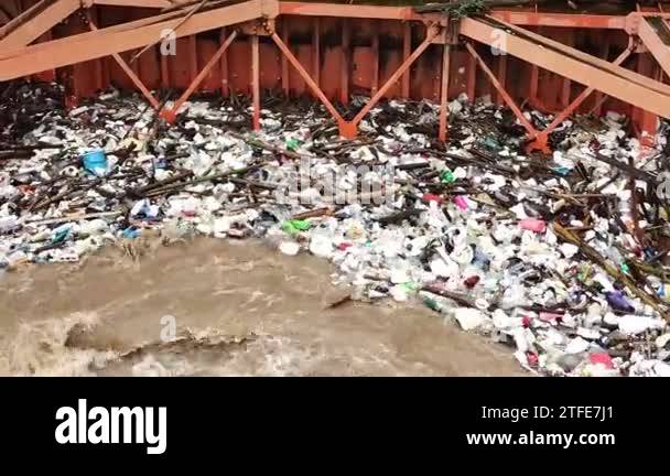 Aerial view of turbid brown forest water released by concrete dam ...
