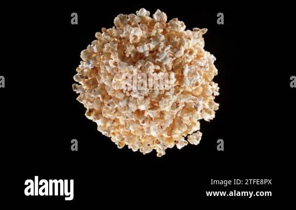 Super slow motion shot of rotating exploded fresh popcorn on black at ...