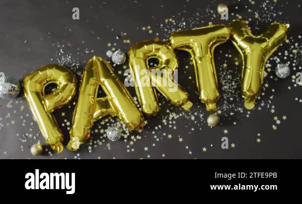 Video of gold balloon party text, with glitter, baubles, mirror balls ...