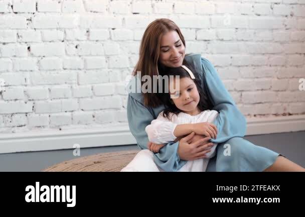 Loving tender young mum holding adorable cute girl daughter embracing ...