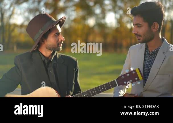 Positive talented Middle Eastern musicians posing at golden sunset in ...