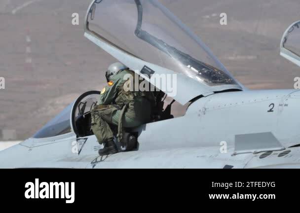 Military pilot descends from the cockpit of modern supersonic NATO ...