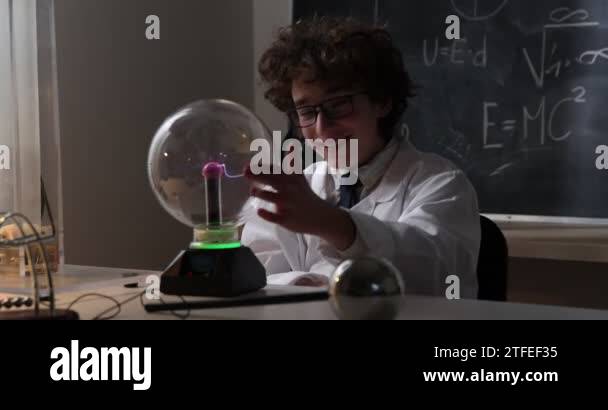 Physics science lab: handsome young scientist in white coat and glasses ...