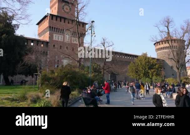 Milan, Italy, March 2022. Tilt footage of the Sforza castle. People ...