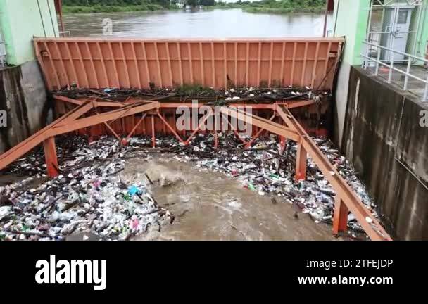Aerial view of turbid brown forest water released by concrete dam ...