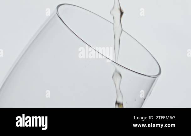 Lager beer pouring glass closeup slow motion. Alcoholic hoppy liquid ...