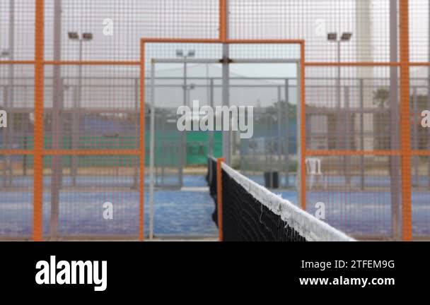 Male padel players handshake after win a padel match in a blue paddel ...
