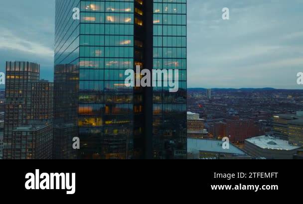 Tight flight around glossy glass facade of modern high rise office ...