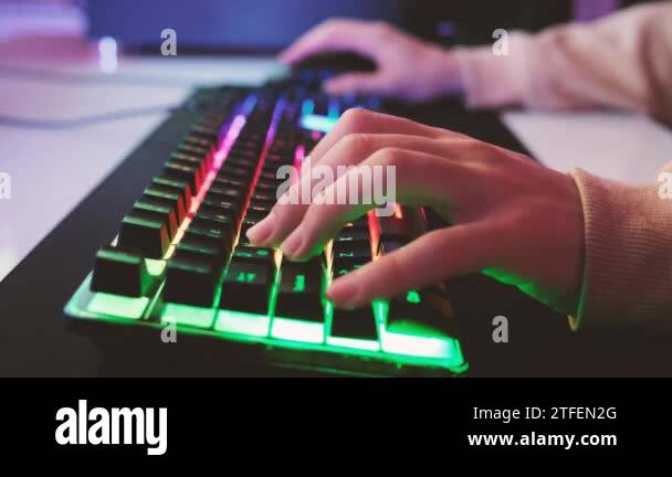 Gamer hands, gamer hands on RGB keyboard, closeup of pro cyber sport ...