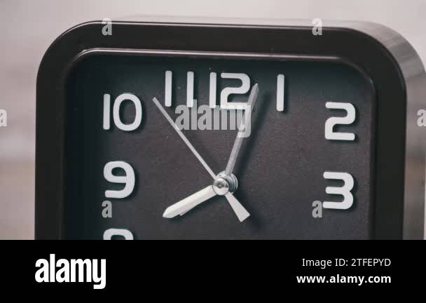 The pointer clock on wooden table shows time 8 oclock. Arrow brown ...