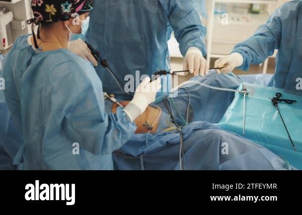 Real process laparoscopy operation. Surgeons team preforming operation ...
