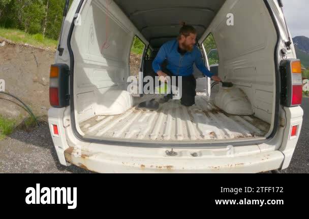 Bearded Man cleaning Campervan, after rust treatment, Van Build old ...