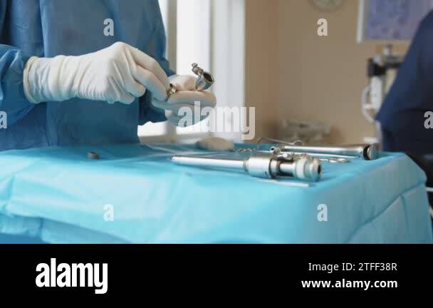 A table of medical tools are placed upon a table in preparation for ...