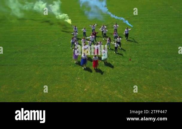 Schoolchildren in Ukrainian costumes dancing flash mob dedicated to peace in the world outdoors ...