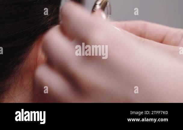 Closeup of ear with hearing aid, young deaf woman adjusting to ...