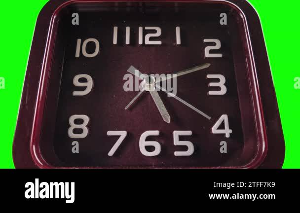 Timelapse of analog clock with spinning watch hands on a green ...