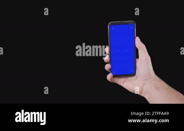 Male hand holding a smartphone with a blue screen with markers on alpha ...