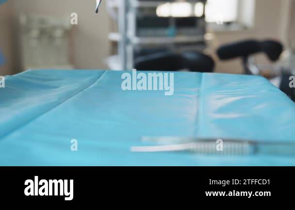 A table of medical tools are placed upon a table in preparation for ...