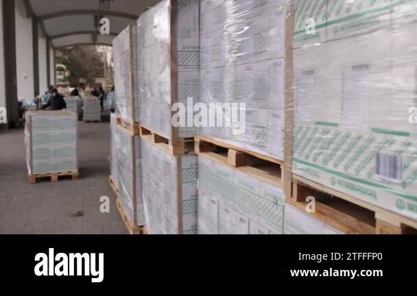 Forklift is lifting cardboard box on wooden pallet at warehouse Stock ...