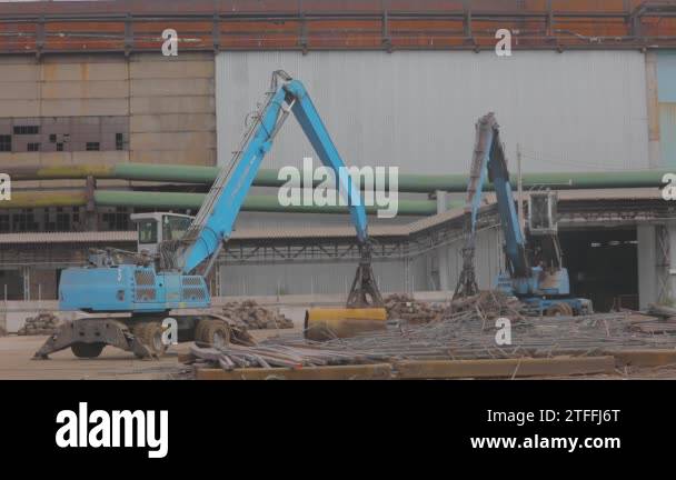 Excavator with grab. Recycling metal waste, metal recycling yard ...