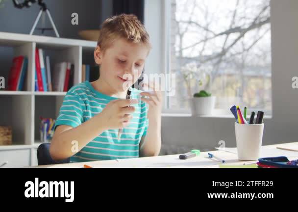 Boy is Doing his Homework at the Table. Cute Child is Learning at Home ...