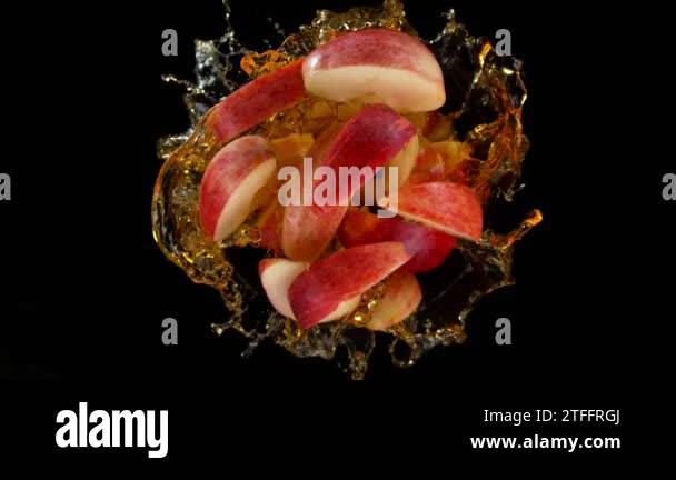 Super slow motion shot of rotating exploded red apple cuts and ...