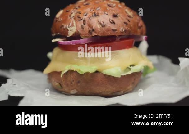 Handmade burger rotates on crumpled paper Stock Video Footage - Alamy