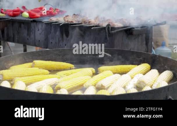 Corn in hot water as street food at a street food fair or festival ...
