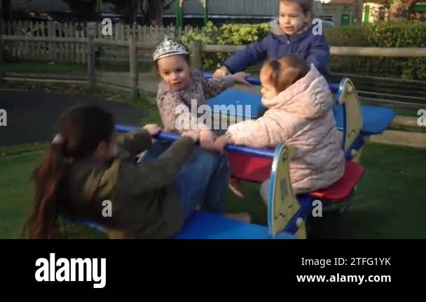Little Happy group Children Different Ege have fun spinning on merry-go ...