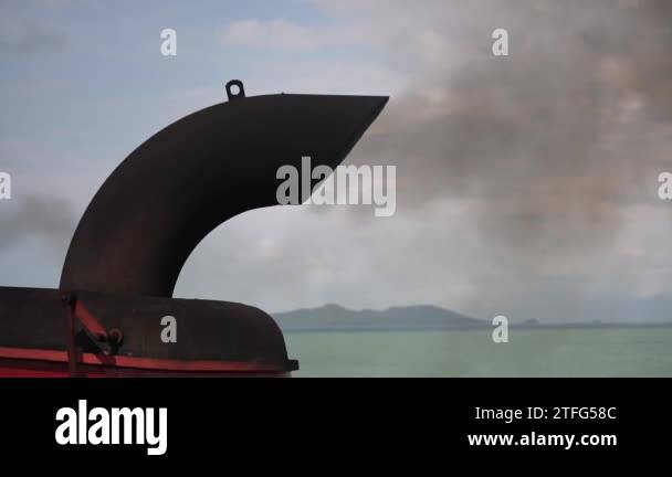 Black smoke from ferry boat flue in background, close up, Thailand ...