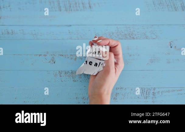 hand holding Mental health text on scrunched up piece of paper ...