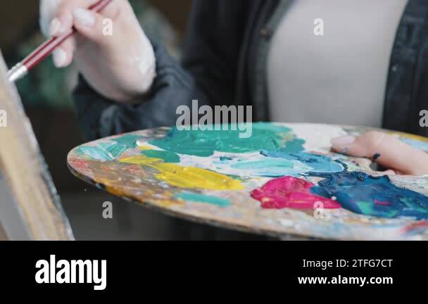 Closeup woman female hand artist painter paints draws creating new art ...