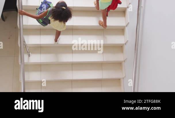 Video of top view of diverse girls walking upstairs at school. primary ...