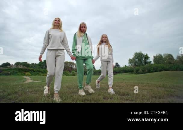 Three generations of a family of women. A happy family walks holding ...