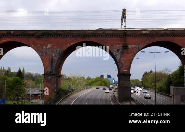 Two electric passenger trains passing on famous arched viaduct above ...