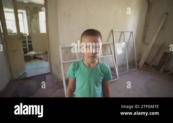 war Ukraine. portrait Ukrainian boy in a destroyed house. a homeless ...
