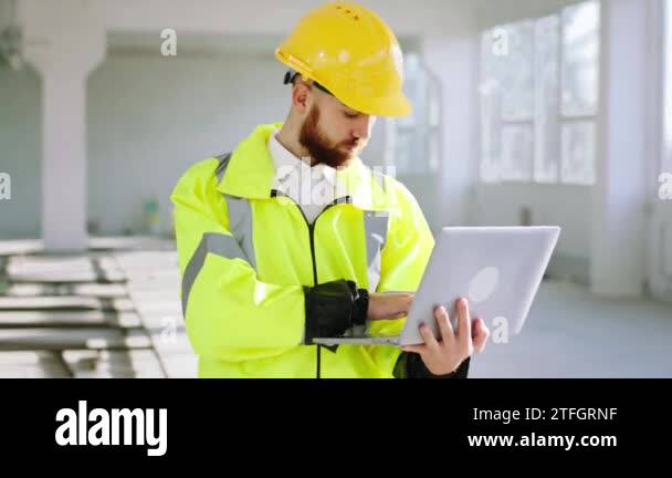 Charismatic engineer man at construction site in a special uniform ...