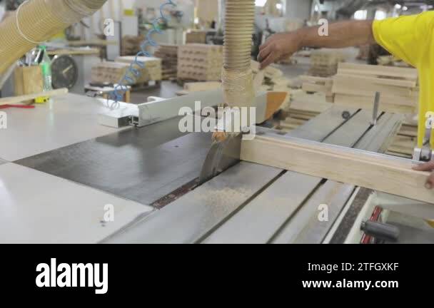 Automated sawing of wood logs. An automated machine saws a piece of ...