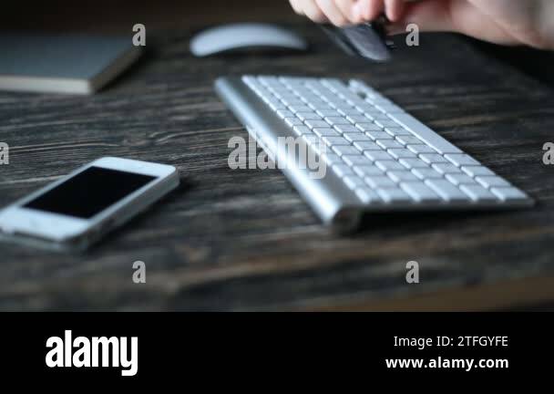 A modern workplace. Night work. A man sits at a computer and types on ...