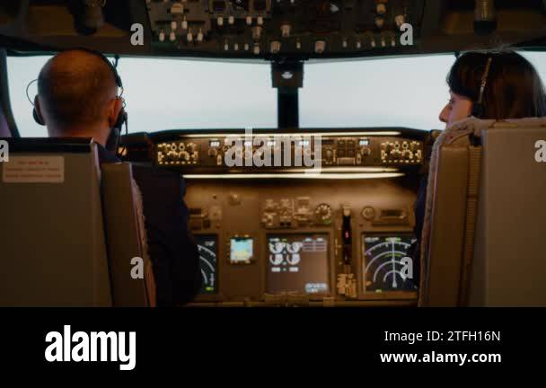 Team of aviators using dashboard buttons to takeoff with plane ...