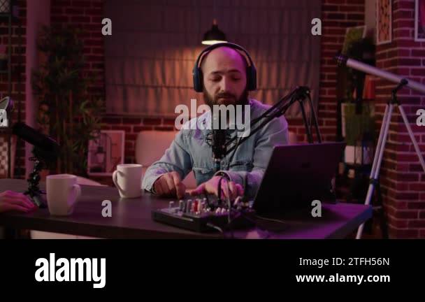 Online radio talkshow host pausing conversation with guest to answer ...