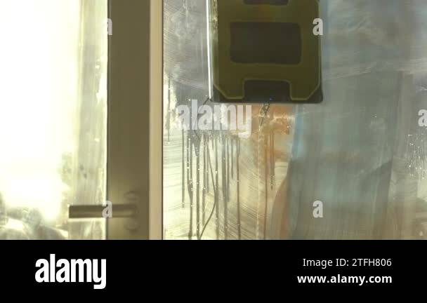 Window with very dirty and dusty glass in daylight. cleaning robot ...