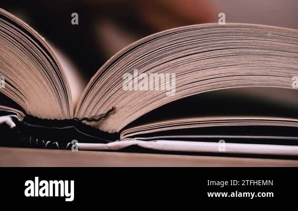Turning pages in a white book close up slow mo. Reading a book ...