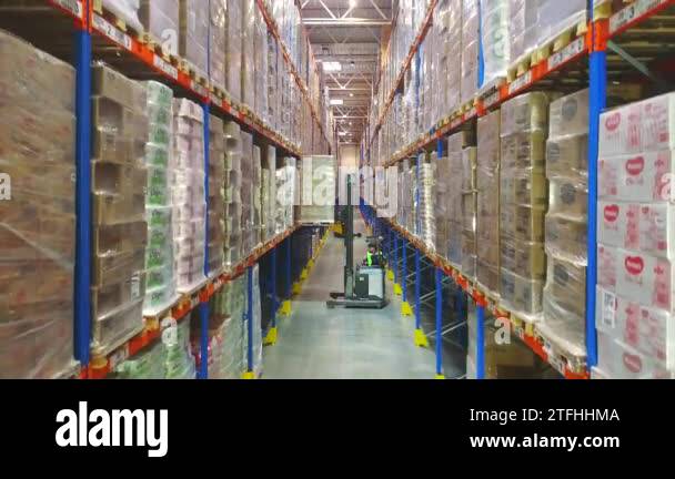 Workflow in a modern warehouse. Modern forklift in a warehouse. Large ...