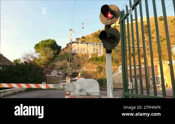 Local commuter train passing level crossing. Alora, Spain - February 9 ...