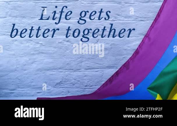 4k zoom in out Rainbow flag with text LIFE GETS BETTER TOGETHER message ...