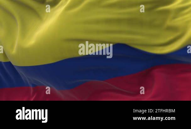 Close-up view of the Colombia national flag waving in the wind. The ...